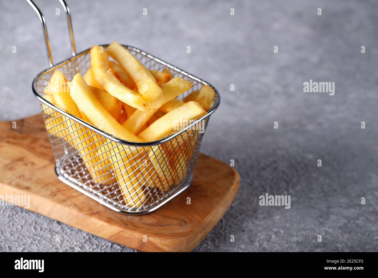 French fries in a metal basket mesh Stock Photo - Alamy