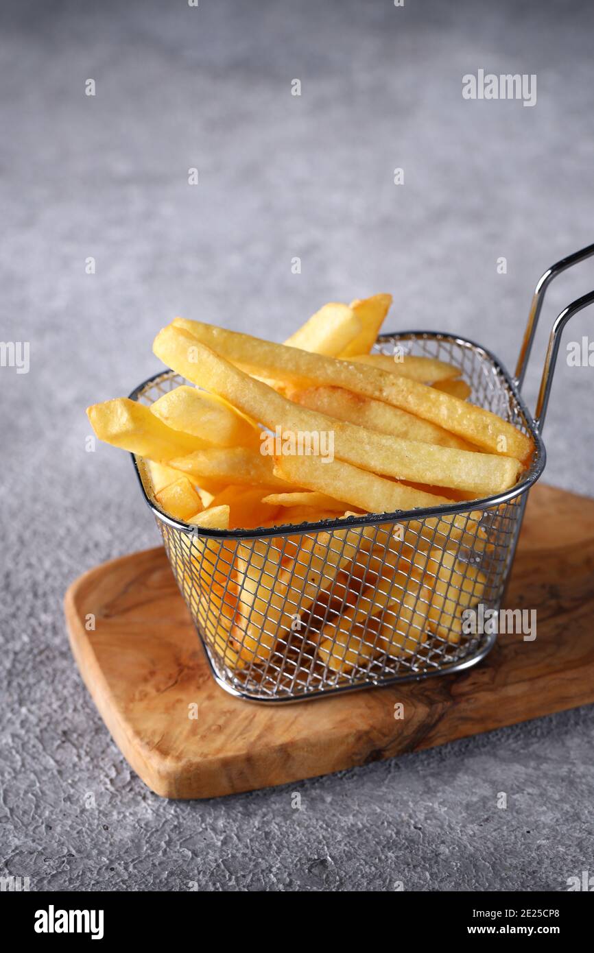 French fries in a metal basket mesh Stock Photo - Alamy