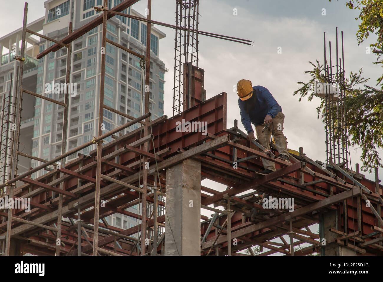 Construction Worker Welding soldering metal girders and Sparks in a ...