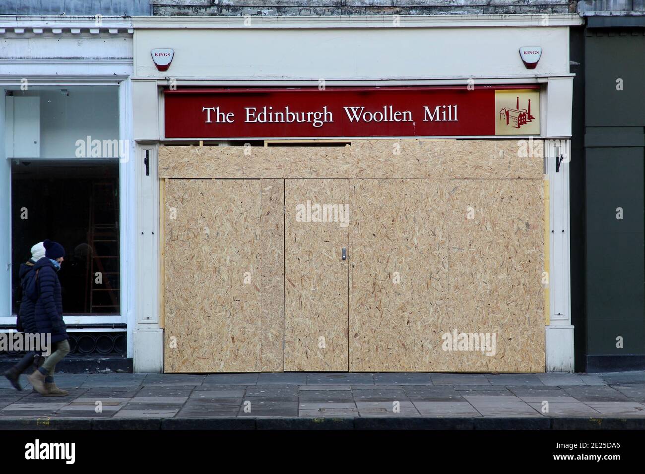 Edinburgh Woollen Mill Shop Boarded up and Two Passers by Stock Photo ...