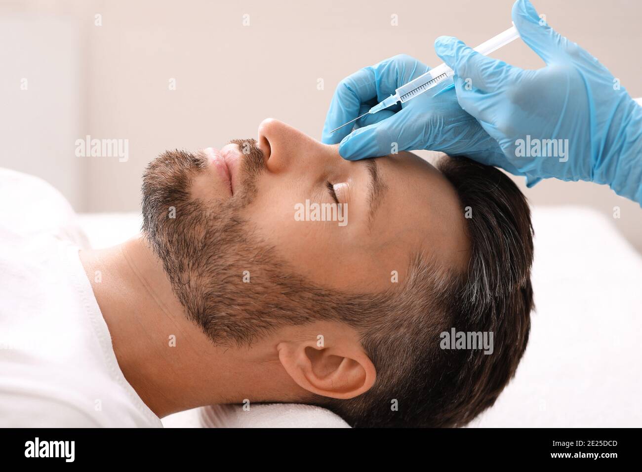 Side view of man getting injection in nose at clinic Stock Photo - Alamy