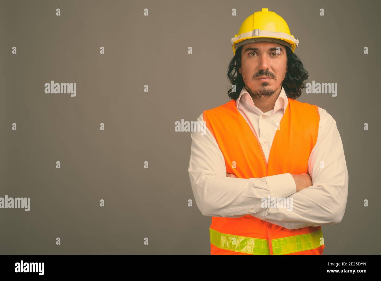 Handsome man construction worker with mustache against gray background ...