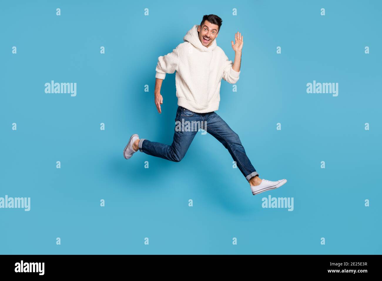 Full size photo of young excited positive happy smiling man jumping ...