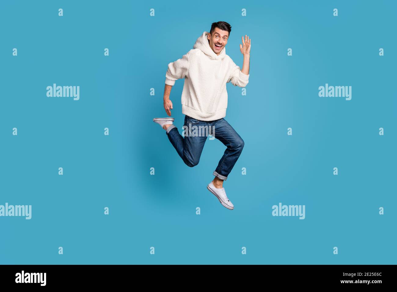 Full size photo of young cheerful positive good mood man smiling jump ...