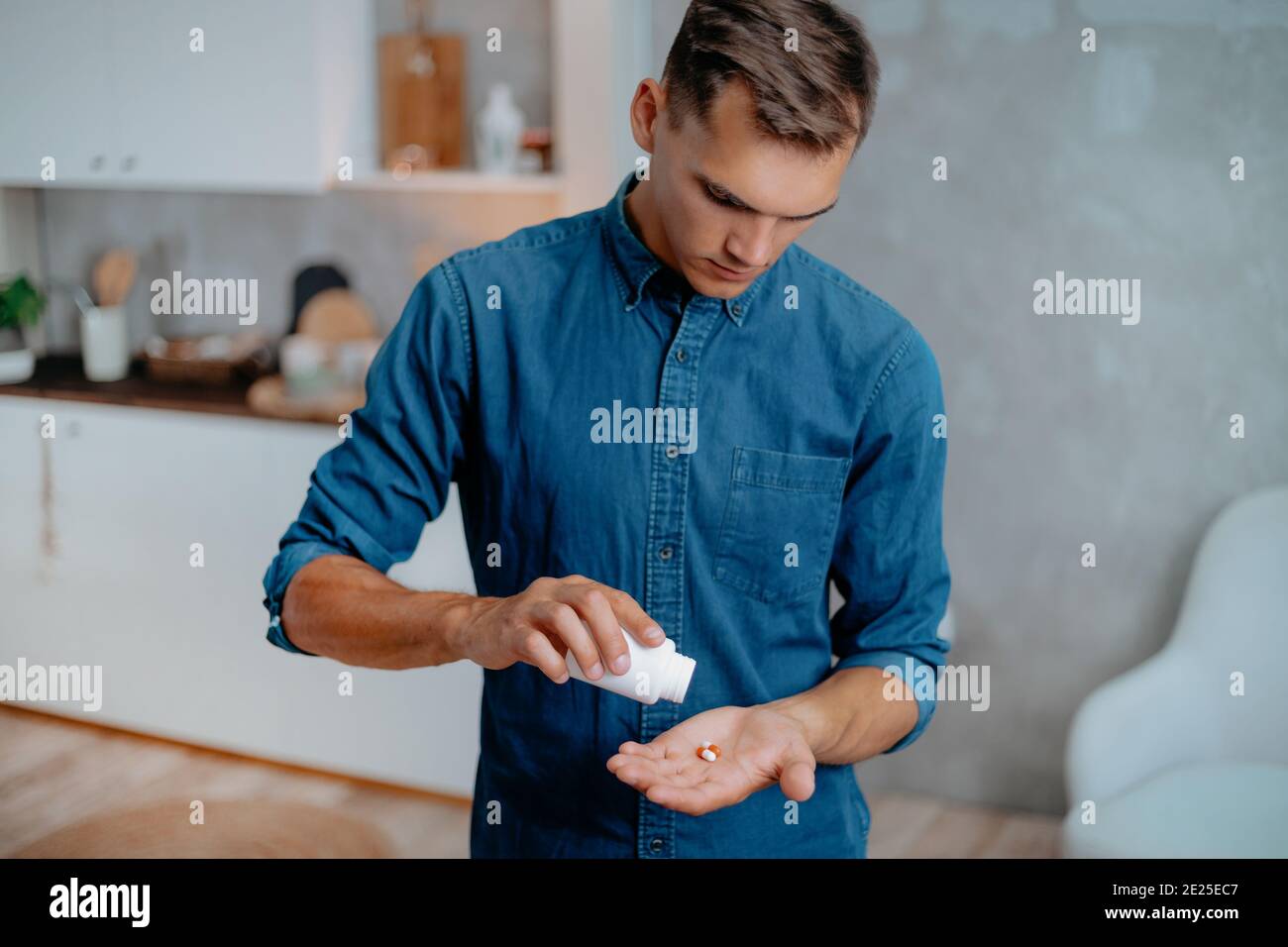 Young men taking medical pill hi-res stock photography and images - Alamy