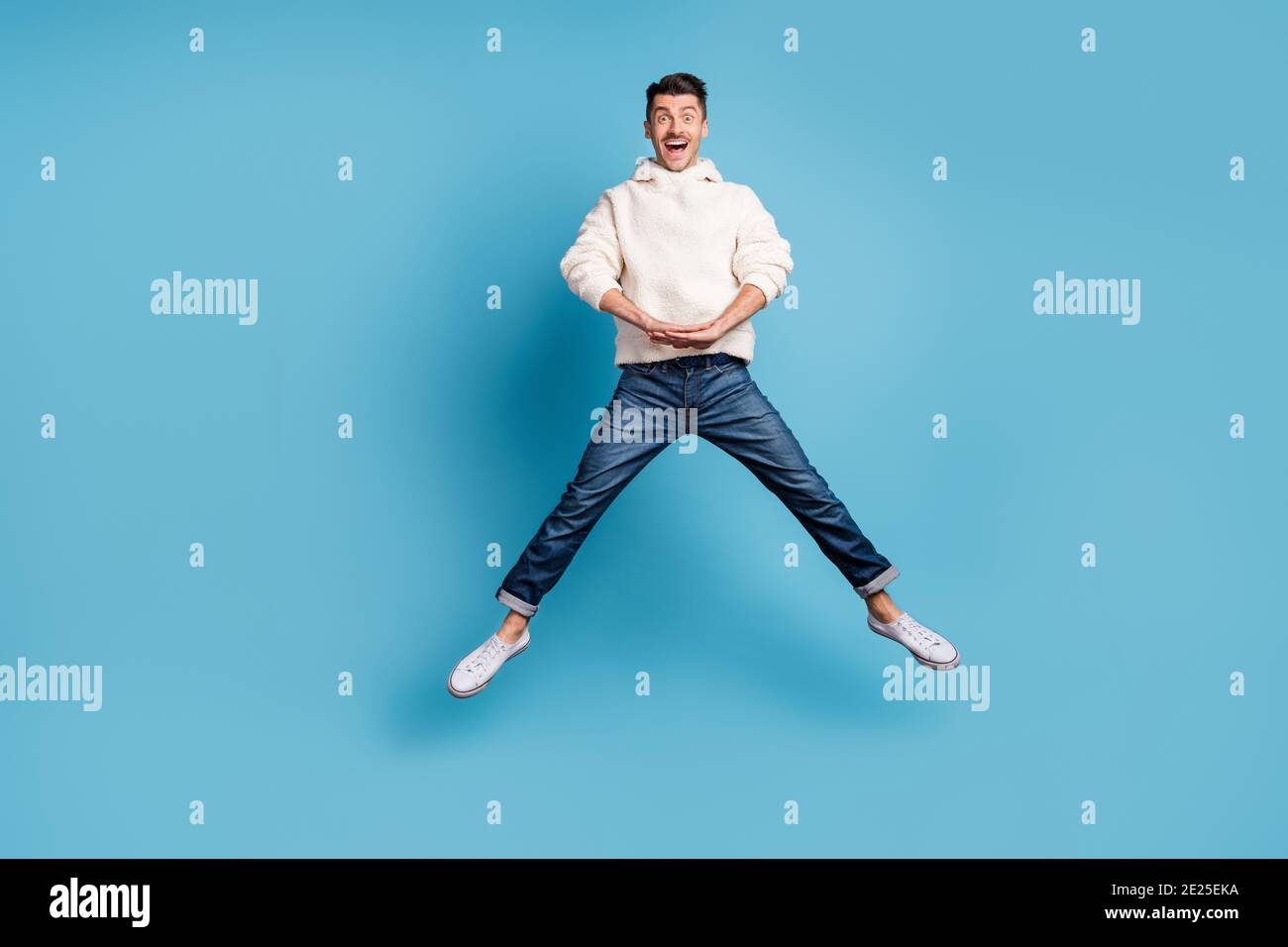 Photo portrait full body view of funny guy jumping up spreading legs ...