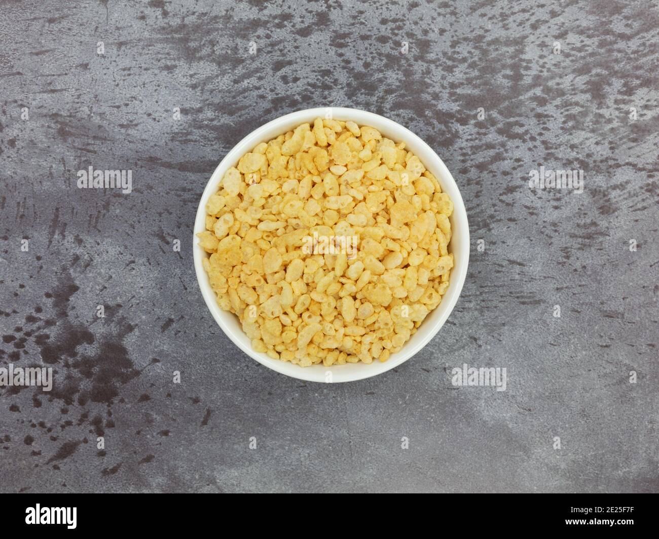 Top view of a white bowl filled with crispy rice breakfast cereal on a ...