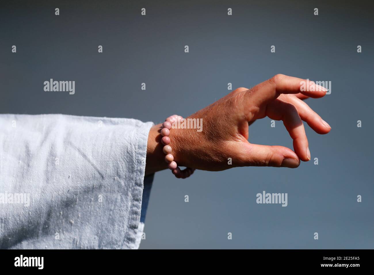 Woman practicing Qi Gong or Tai Chi exercise in nature. Close up on ...