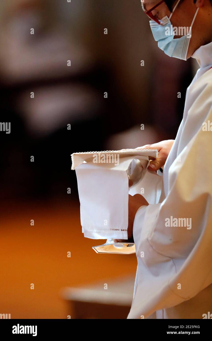Catholic church during covid-19 epidemic. Sunday mass. Altar boy at ...