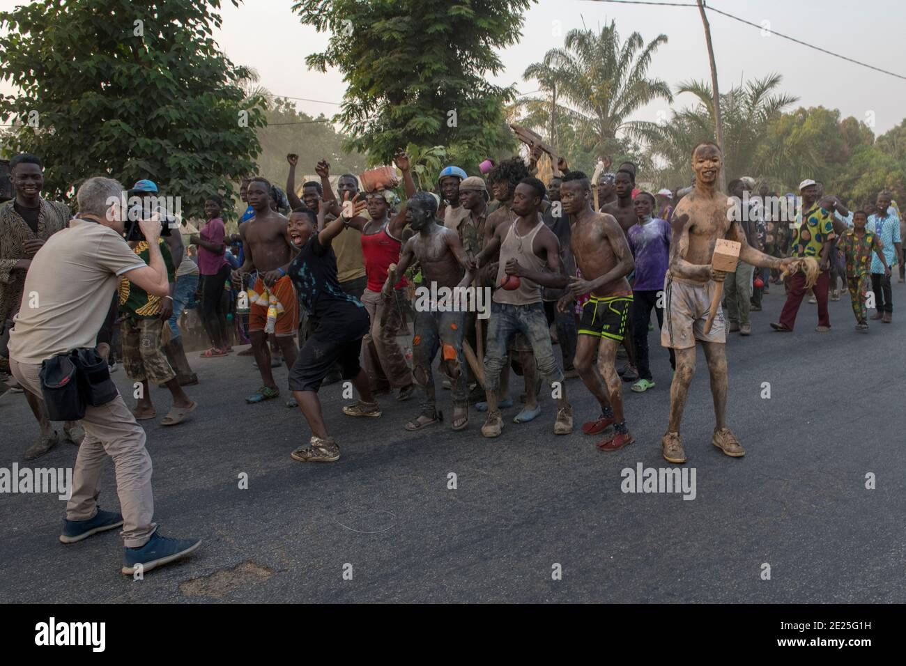 Photographer taking shots of a group of young men gathering for a ...