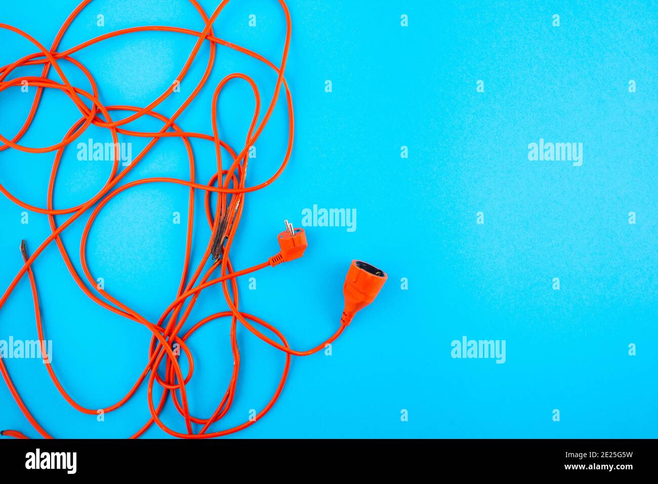 Orange electrical wire on blue background. copy space Stock Photo - Alamy