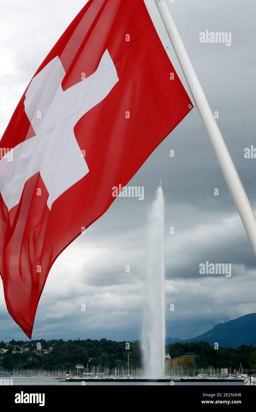 Swiss flag and Jet d'Eau, the world's tallest fountain, on Lake Geneva ...