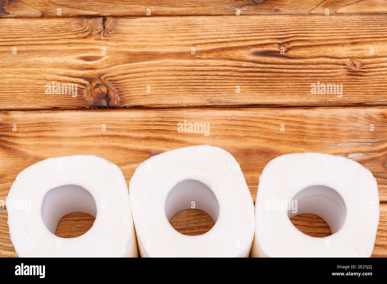 Toilet paper rolls on wooden background top view Stock Photo - Alamy