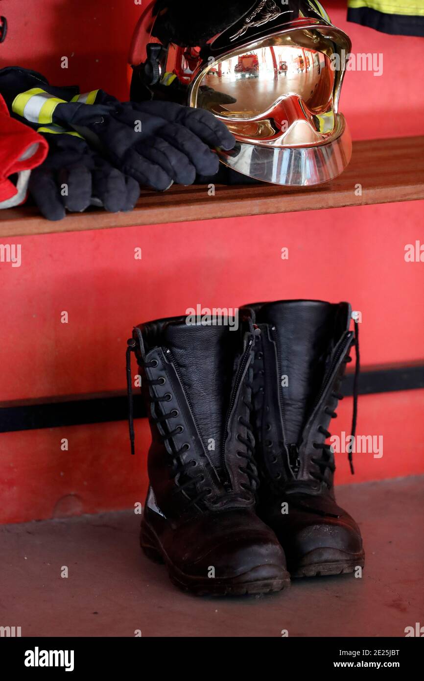 Fire department. Fireman coats, helmets and boots wait for the next ...