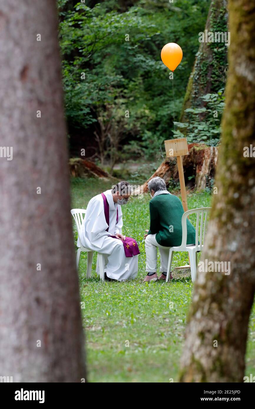 Catholic church during covid-19 epidemic. A penitent confessing his ...