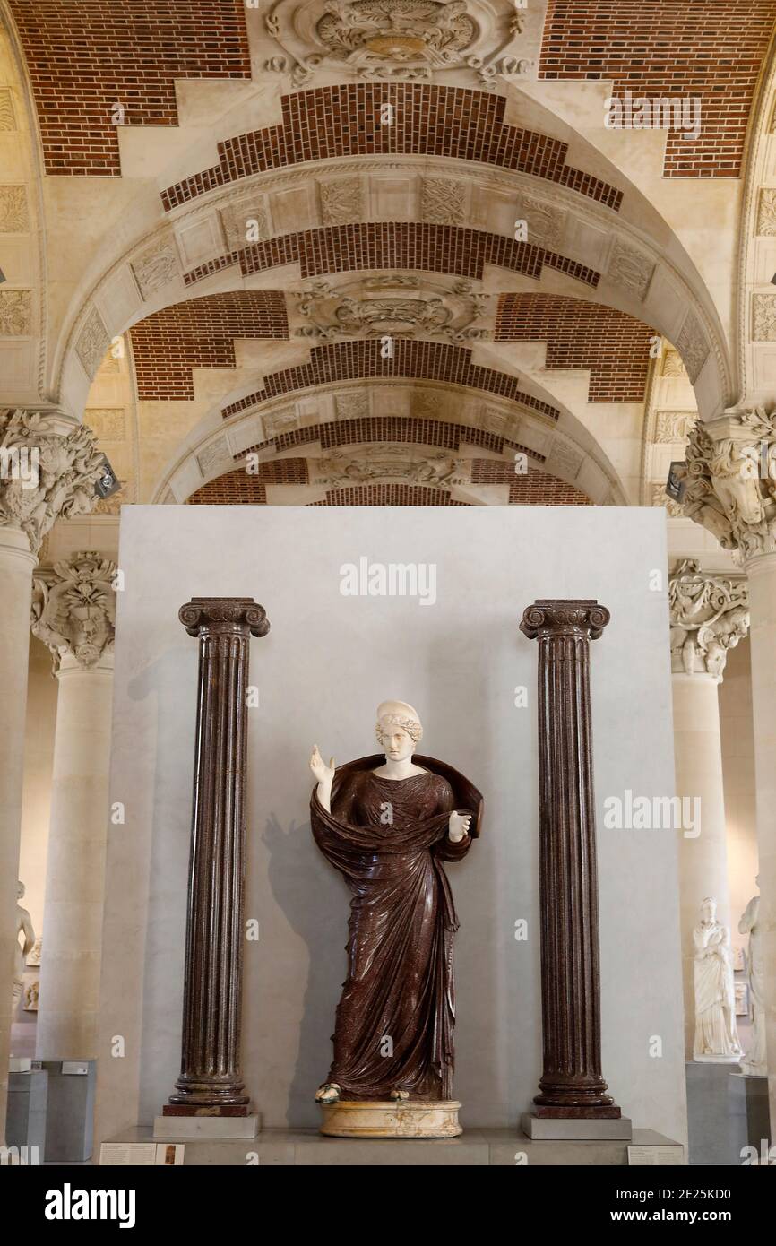 Louvre museum, Paris, France. Woman praying between two Ionic columns ...