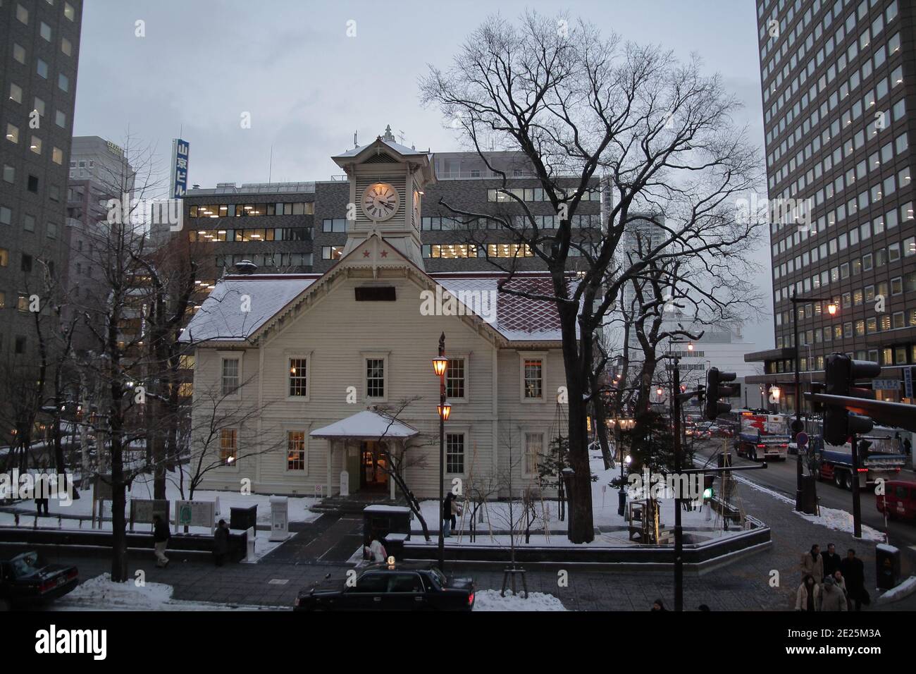 The winter cityscape at dusk with the famous Clock Tower in Sapporo ...