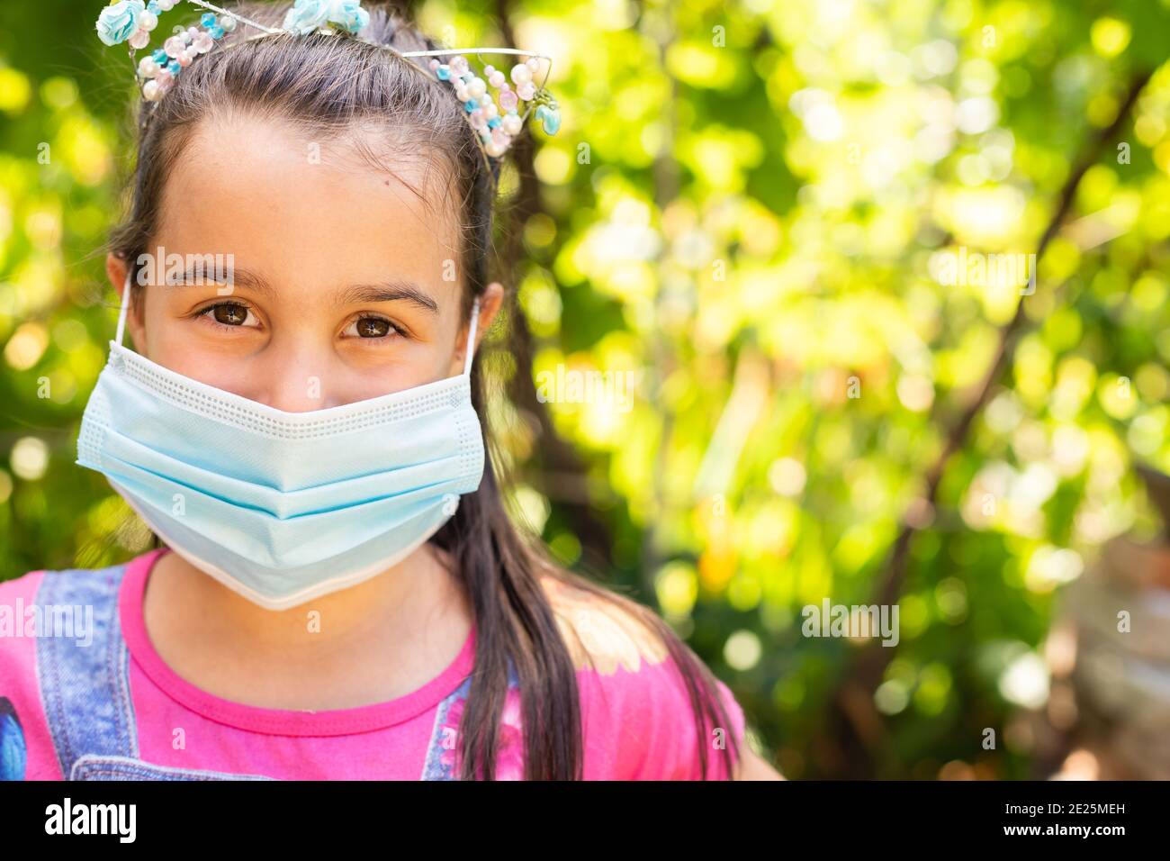 Little girl wearing a protective mask Stock Photo - Alamy