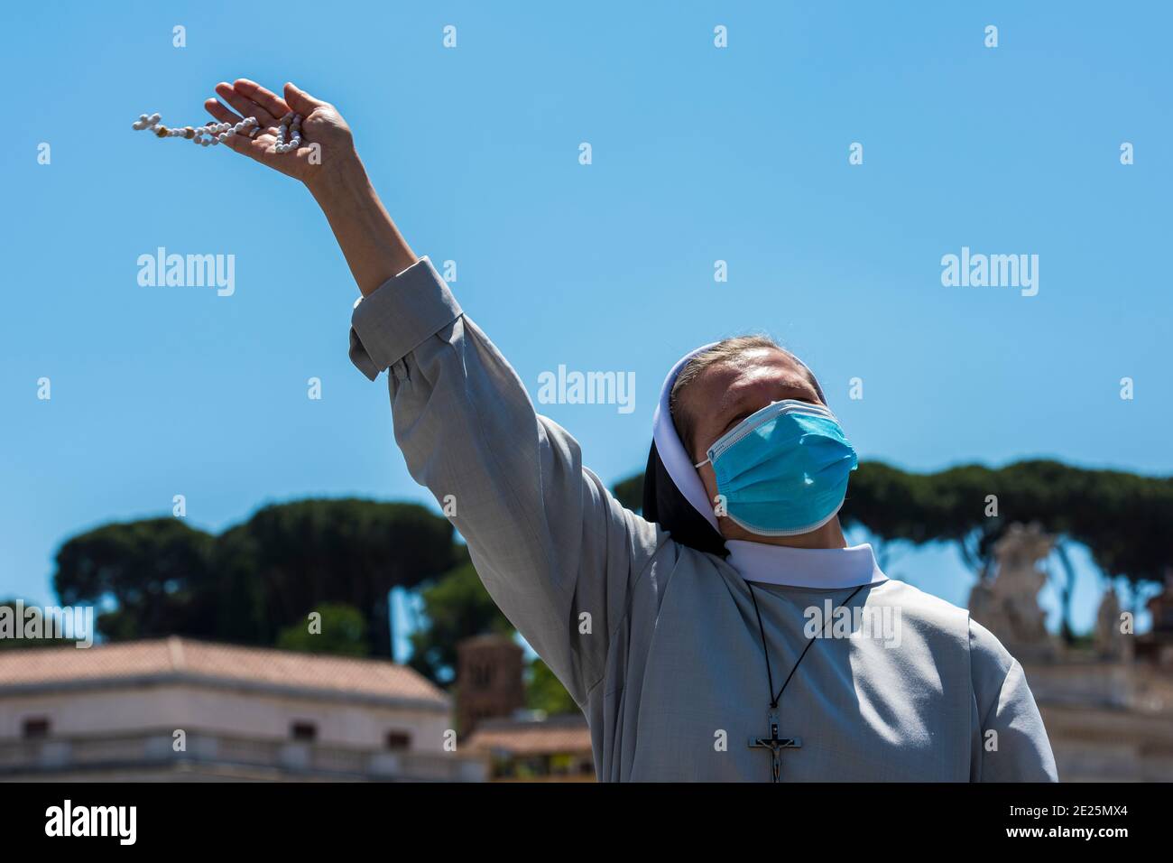 Nun wearing protective facemask praying the holy rosary in Saint Peter ...