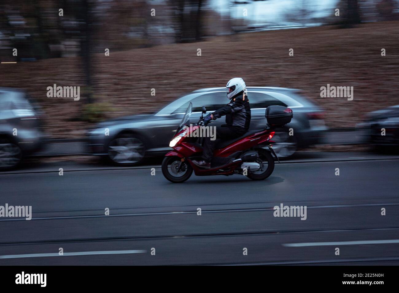 Selective focus shot of a man driving his motorcycle with long exposure ...