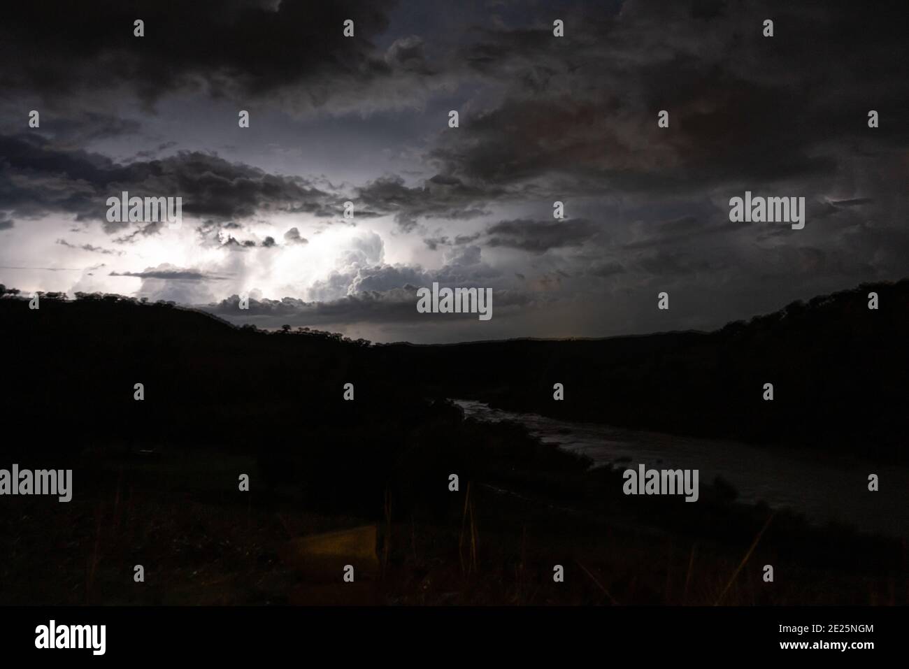 Strong lightning in and behind big towering thunderclouds Stock Photo ...