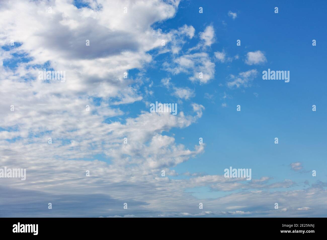 White fluffy clouds spread across the sky, revealing pure blue and ...