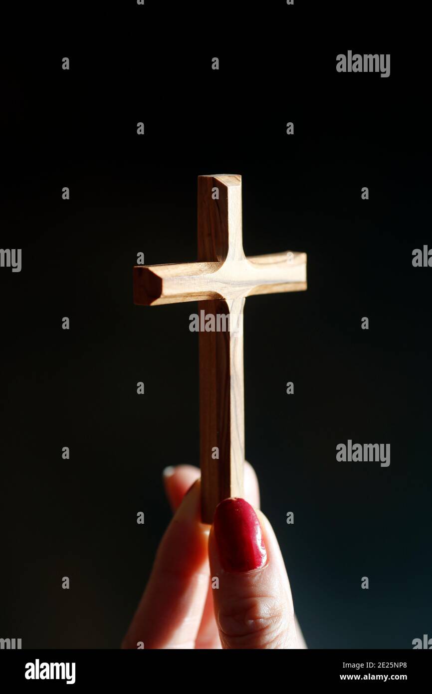 Christian wooden cross in hand. Faith and spirituality. France Stock ...