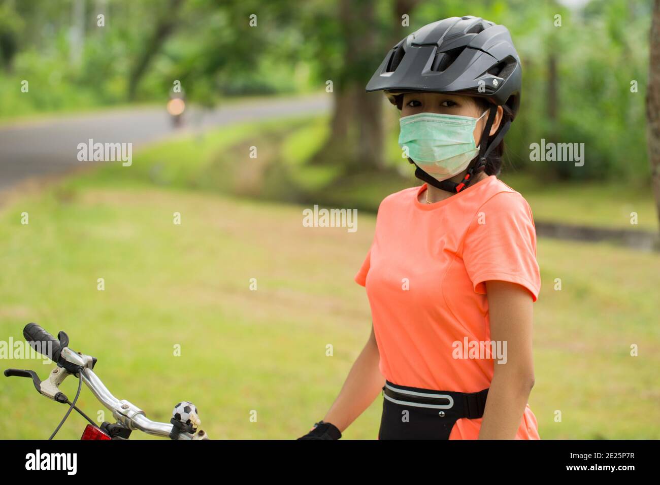 Beautiful asian woman cyclist wearing face mask Stock Photo - Alamy