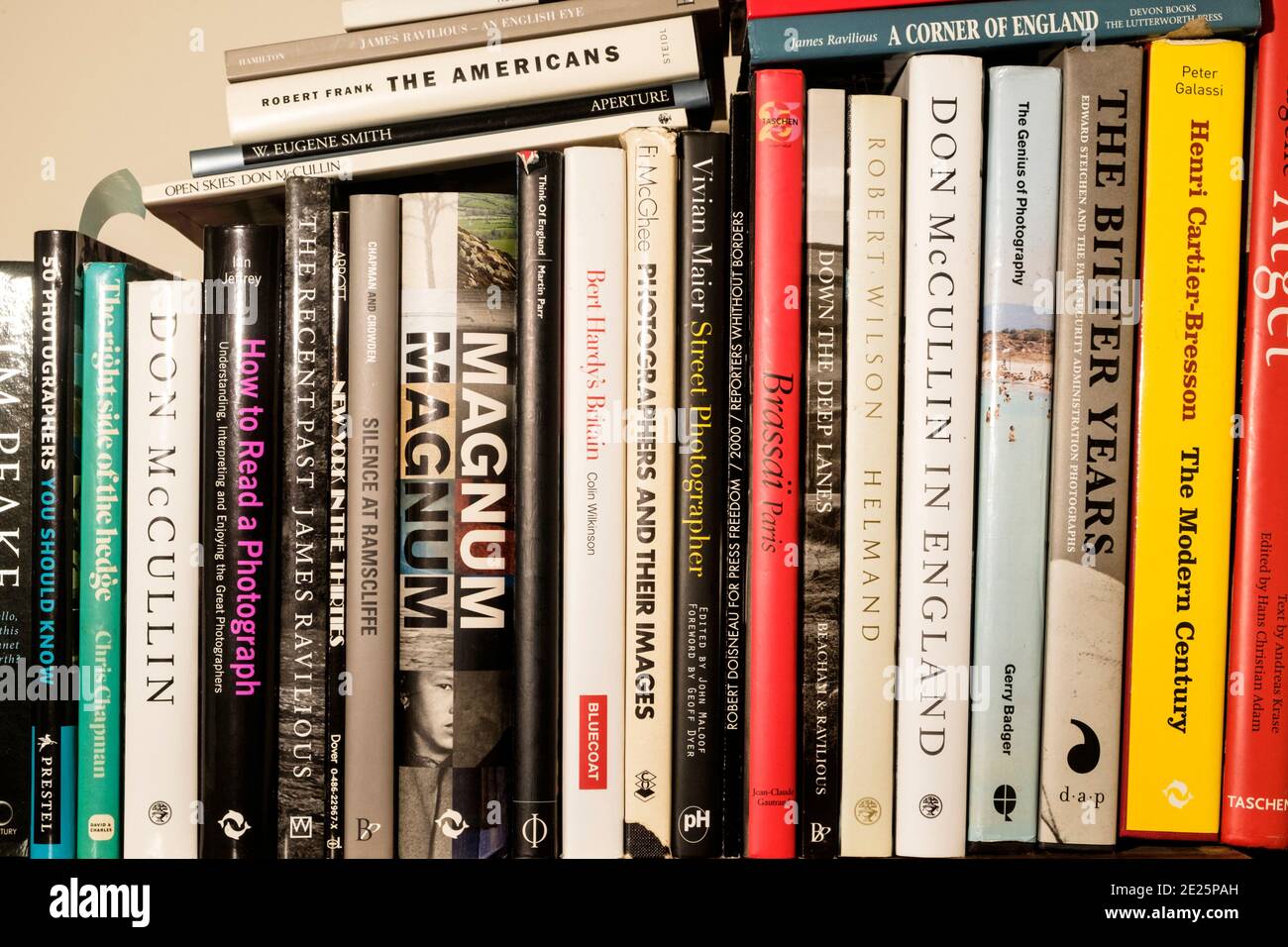 A selection of Photographic books untidily arranged on a shelf Stock ...
