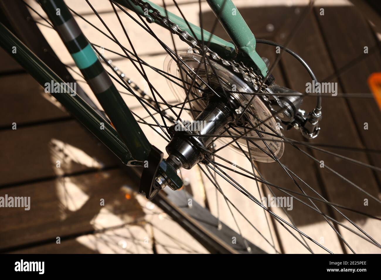 Closeup shot of a back wheel and chains and some parts of a bicycle ...