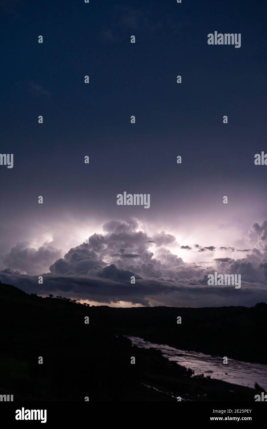 Strong lightning in and behind big towering thunderclouds Stock Photo ...