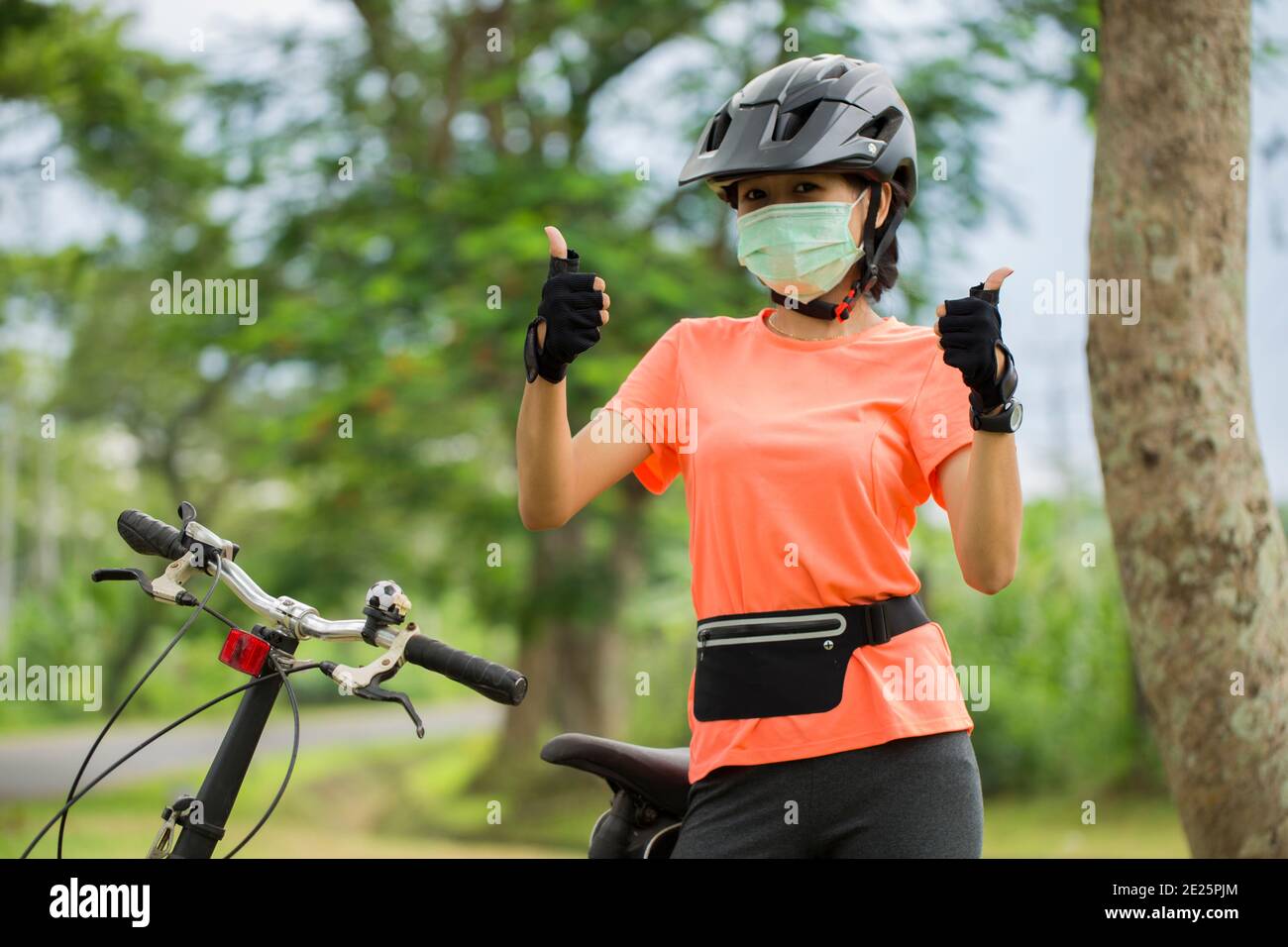 Beautiful asian woman cyclist wearing face mask Stock Photo - Alamy
