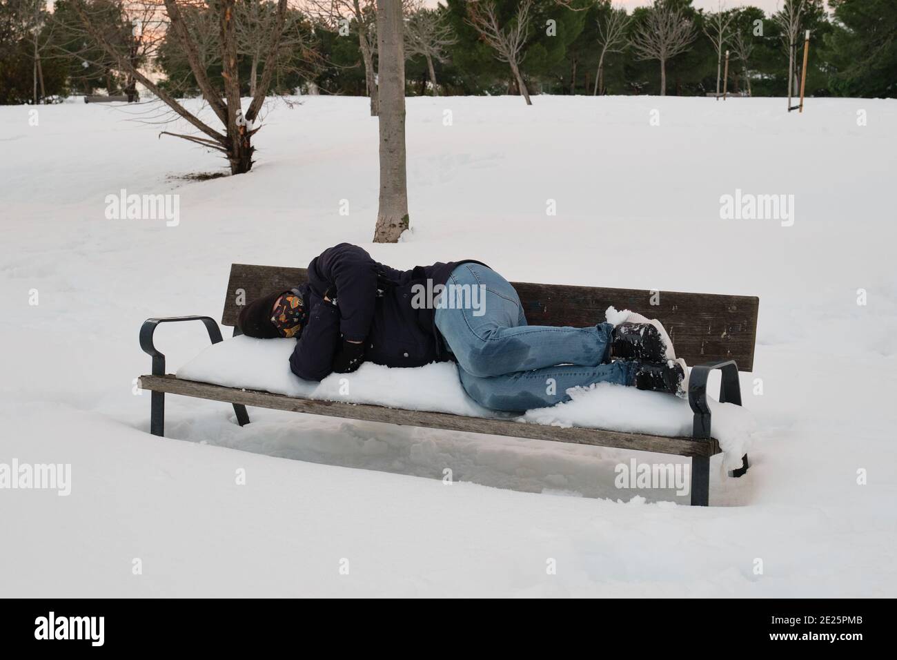 Homeless man sleeping on bench hi-res stock photography and images - Alamy