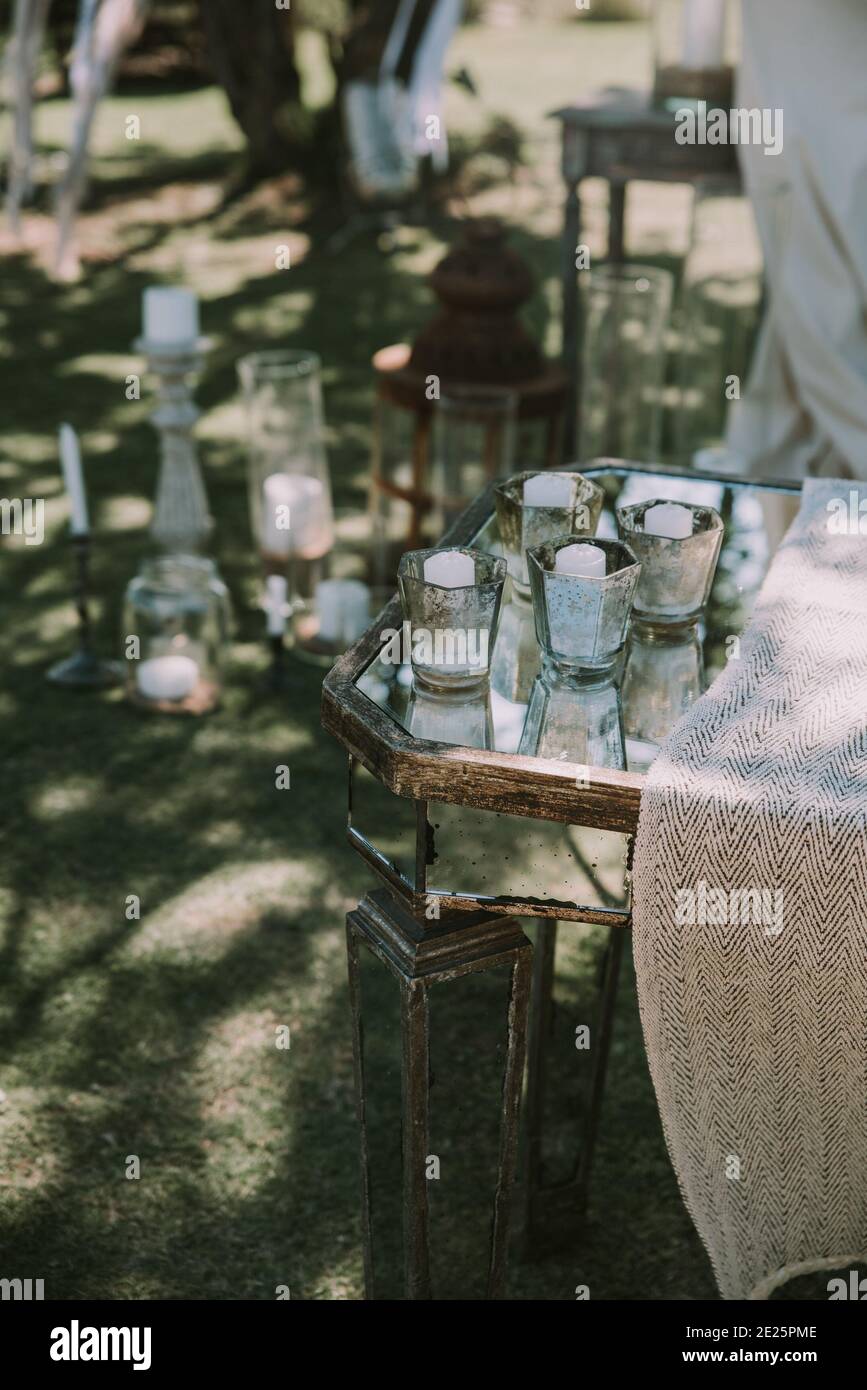 glass table with candles and chairs Stock Photo - Alamy