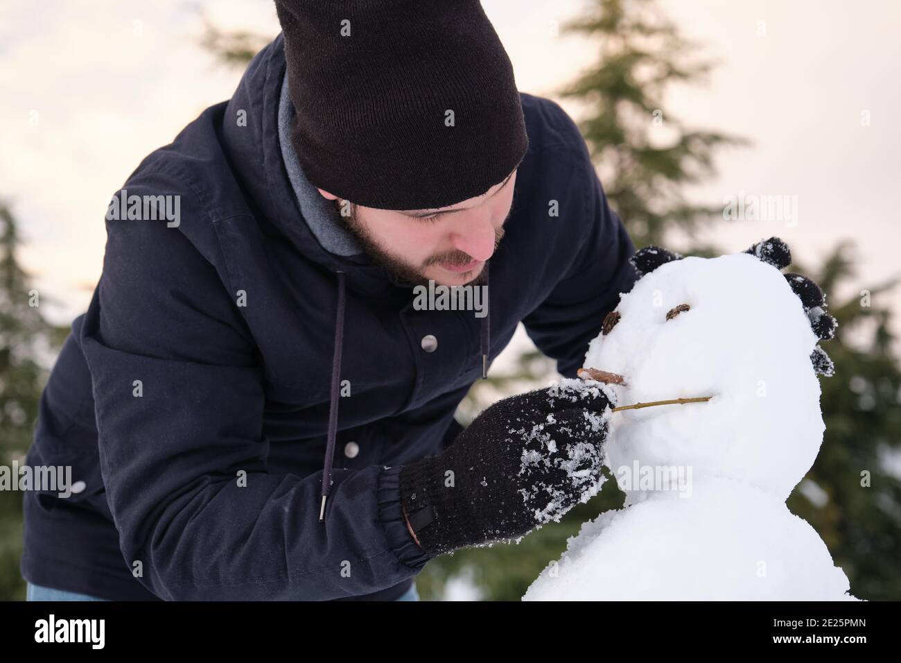 Man making snowball hi-res stock photography and images - Alamy
