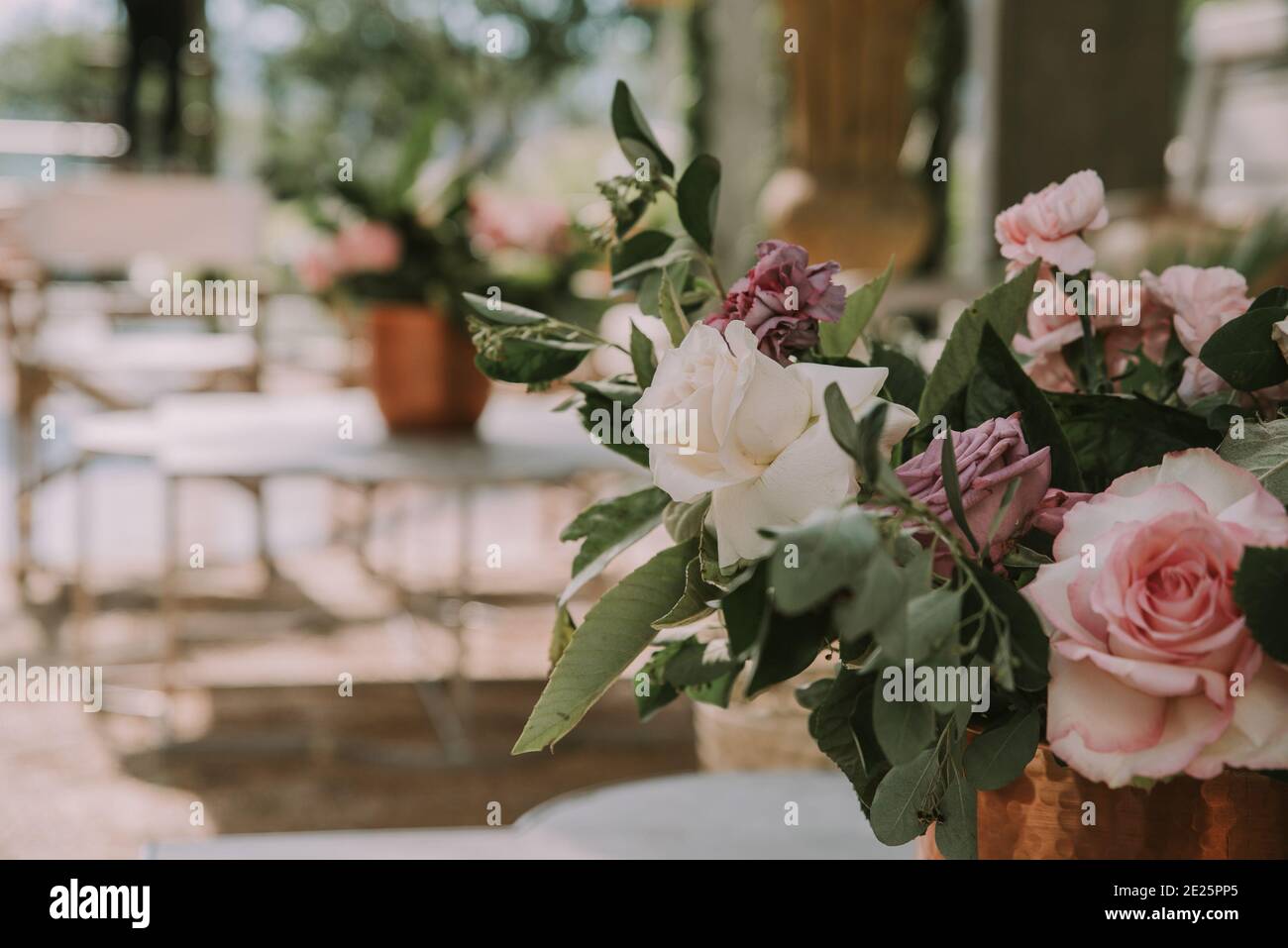 wooden tables and chairs with colorful flowers Stock Photo - Alamy