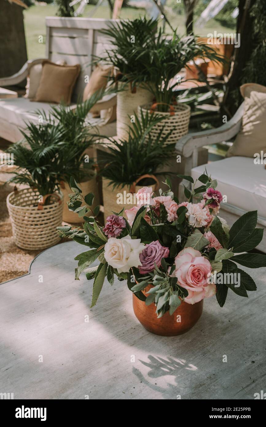 wooden tables and chairs with colorful flowers Stock Photo - Alamy