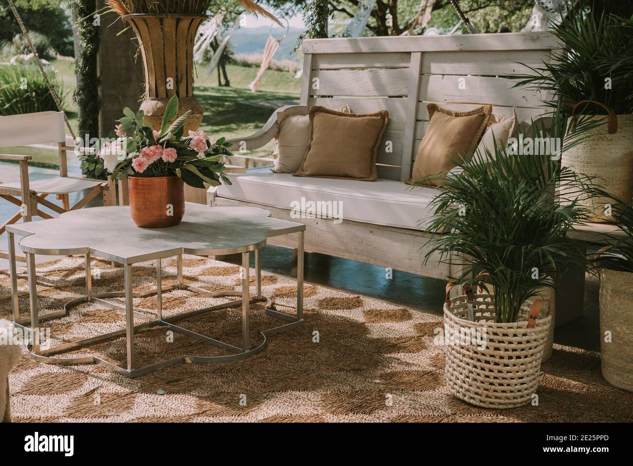 wooden tables and chairs with colorful flowers Stock Photo - Alamy