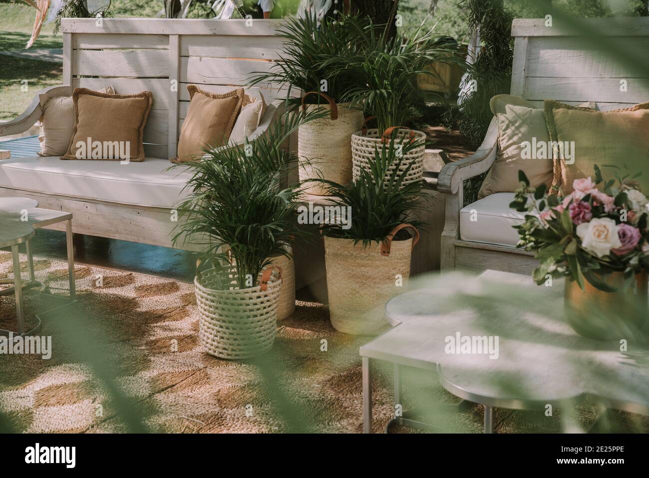 wooden tables and chairs with colorful flowers Stock Photo - Alamy
