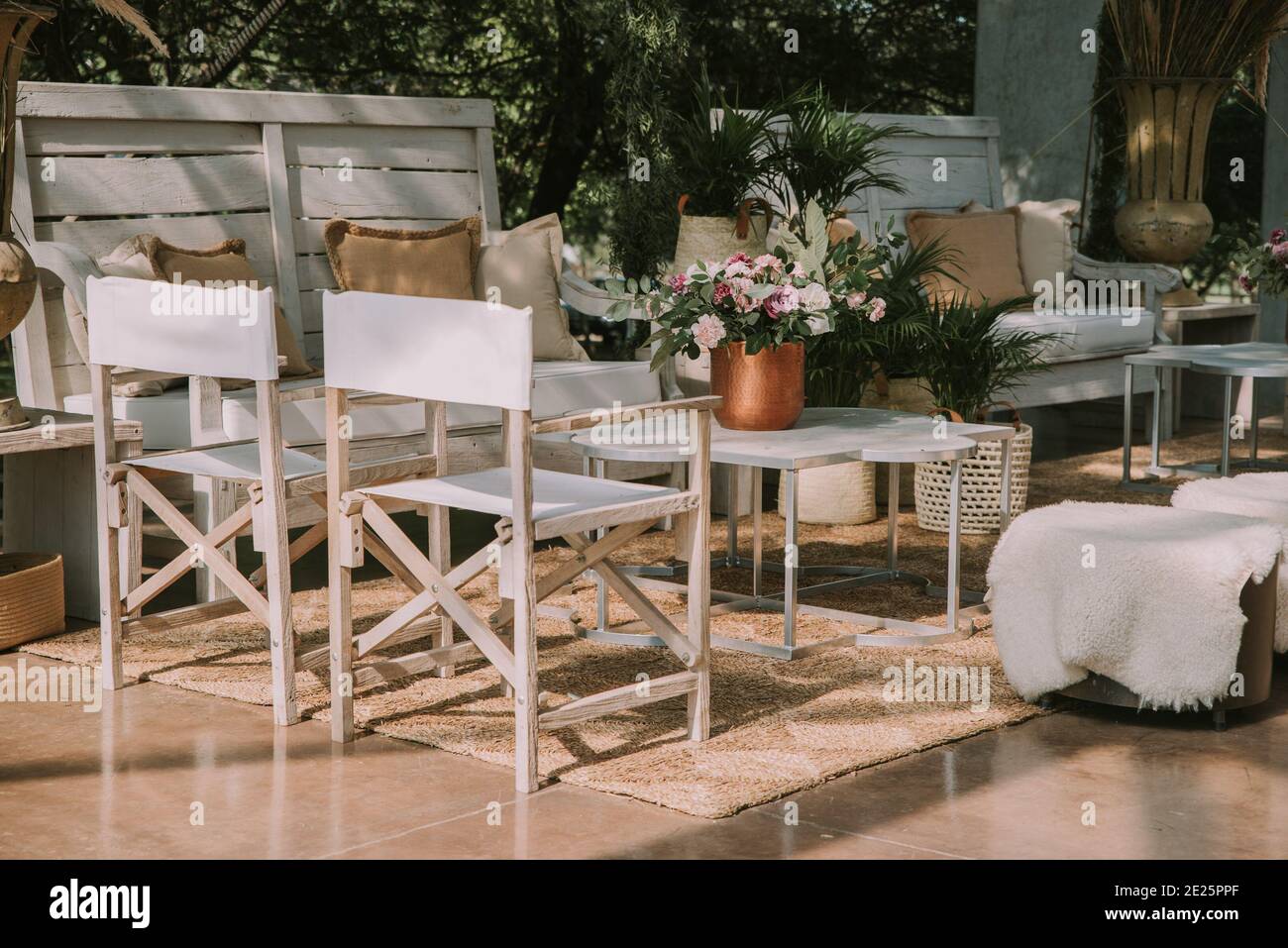 wooden tables and chairs with colorful flowers Stock Photo - Alamy