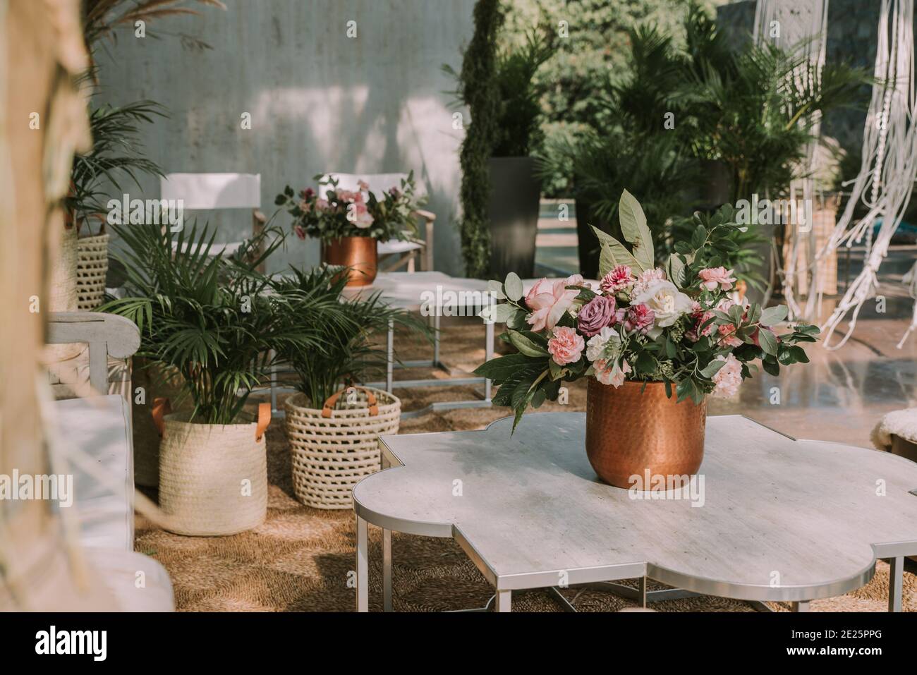 wooden tables and chairs with colorful flowers Stock Photo - Alamy