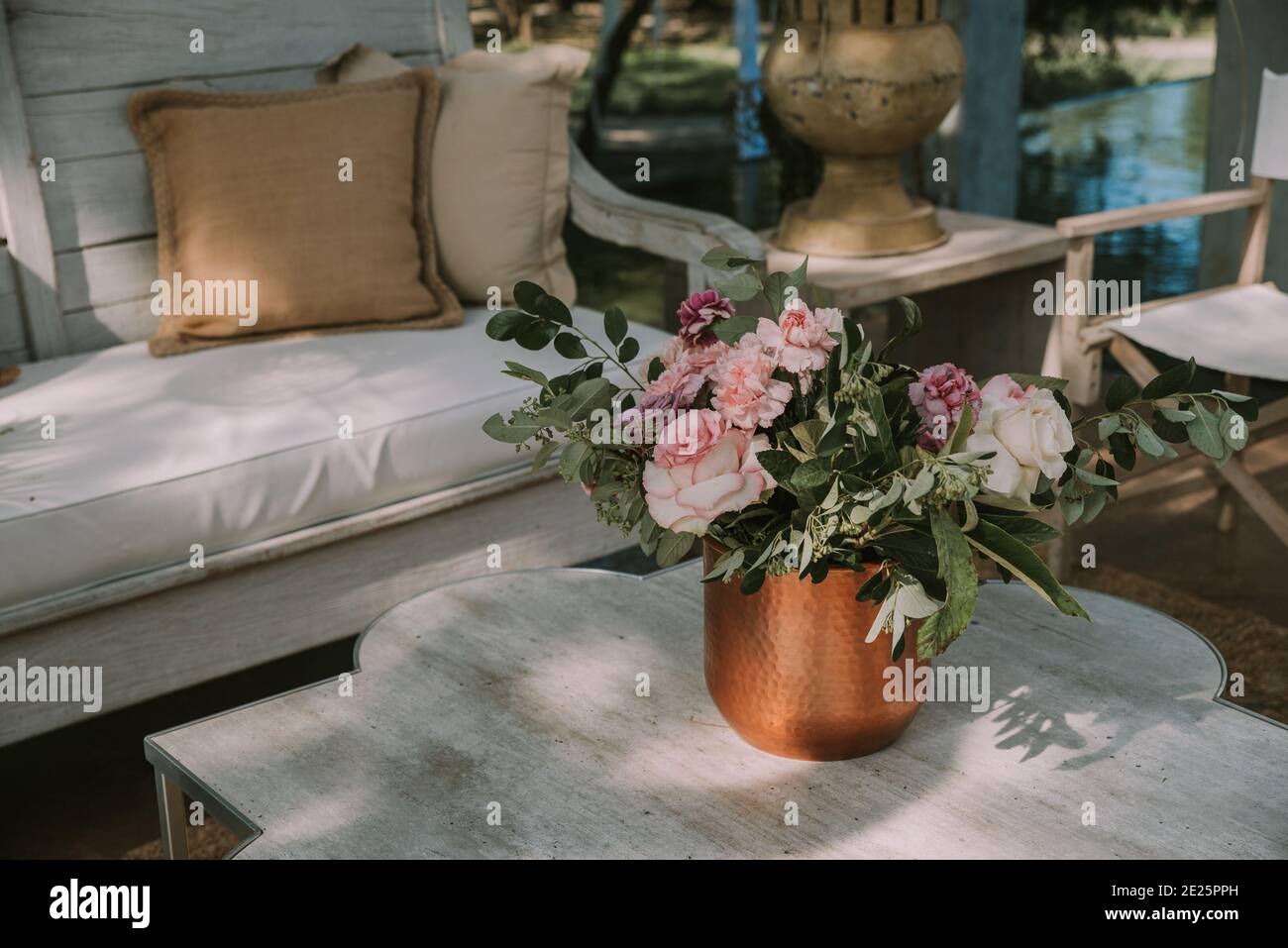 wooden tables and chairs with colorful flowers Stock Photo - Alamy