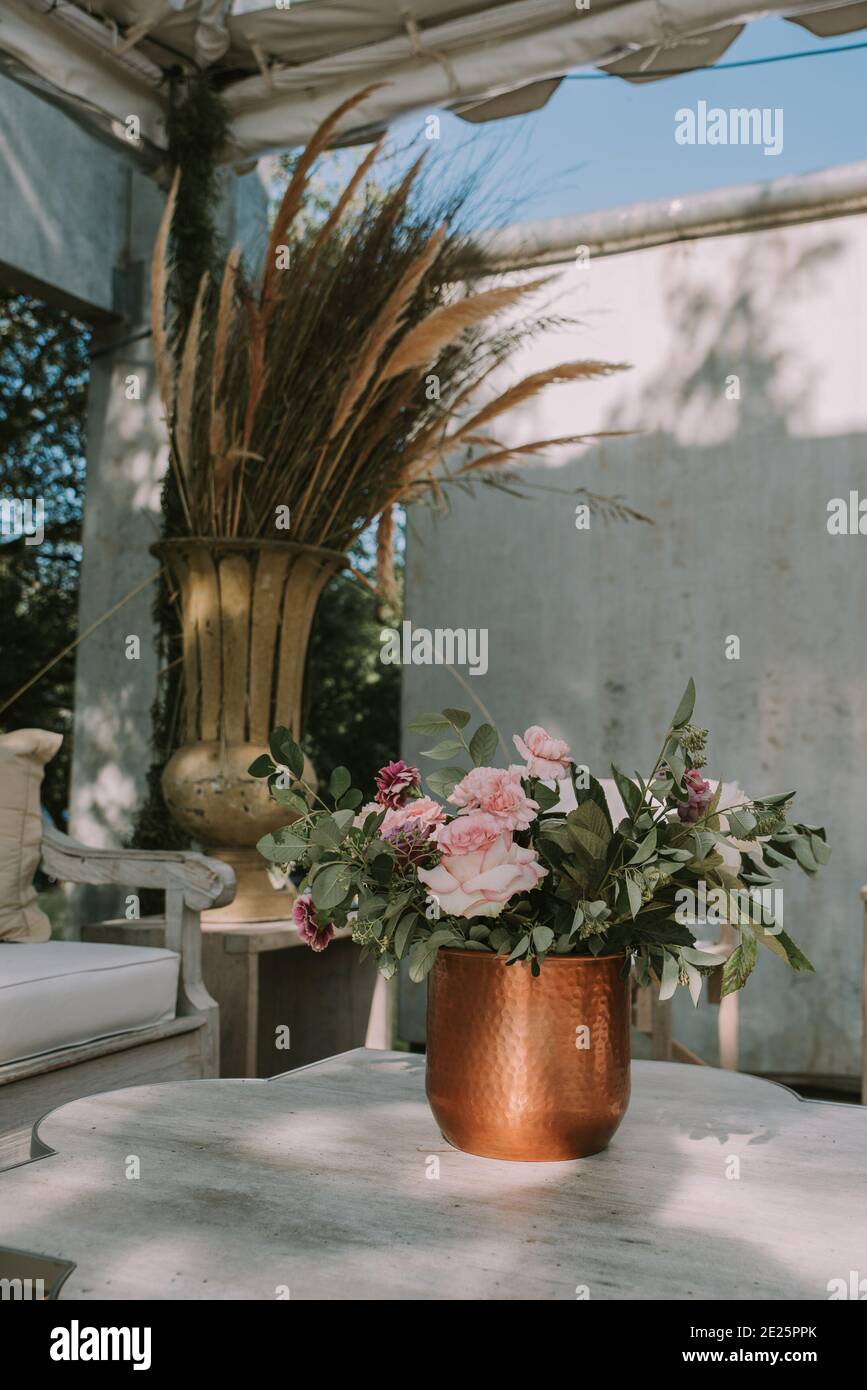 wooden tables and chairs with colorful flowers Stock Photo - Alamy