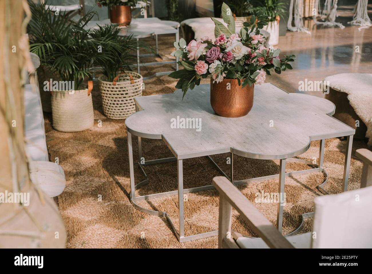 wooden tables and chairs with colorful flowers Stock Photo - Alamy
