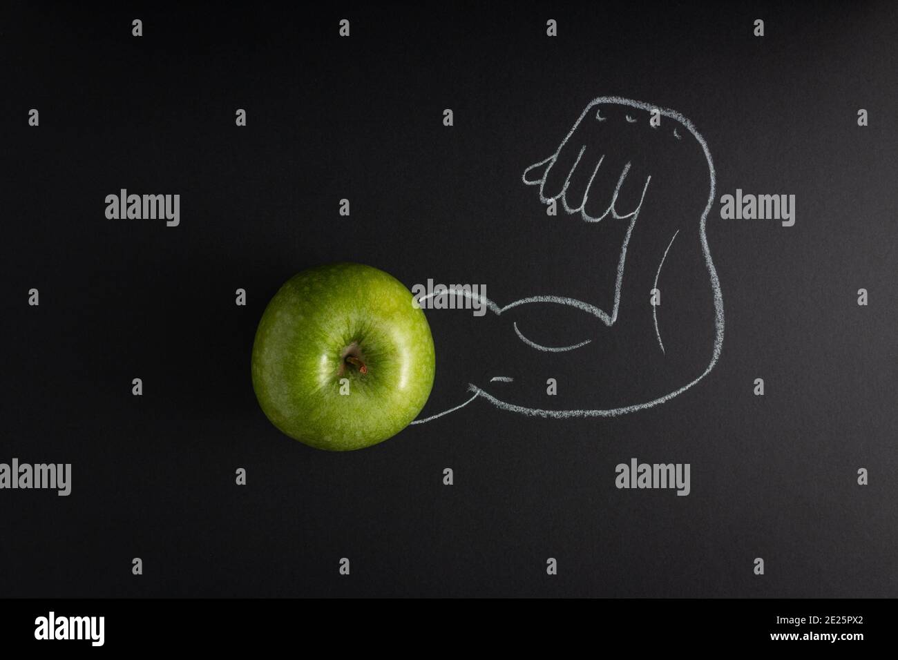 Fresh green apple and a strong arm showing its biceps muscle drawn in ...