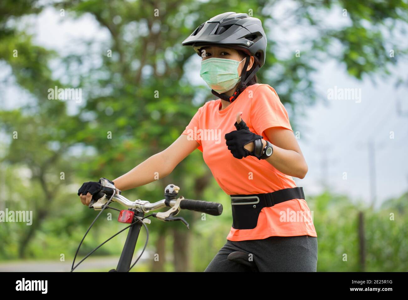 Beautiful asian woman cyclist wearing face mask Stock Photo - Alamy