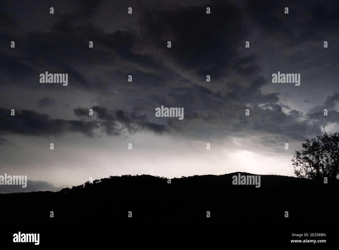 Strong lightning in and behind big towering thunderclouds Stock Photo ...