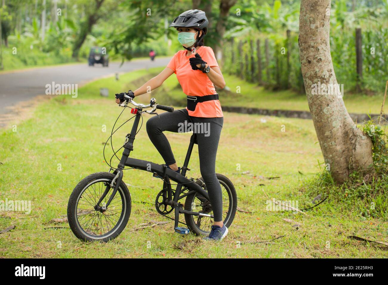 Beautiful asian woman cyclist wearing face mask Stock Photo - Alamy