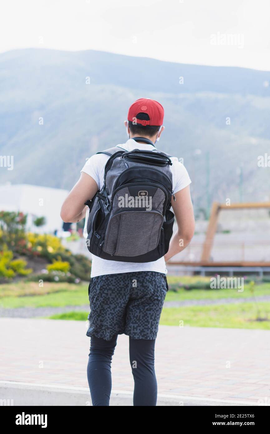 Young man with a black backpack with clothes and accessories for doing ...