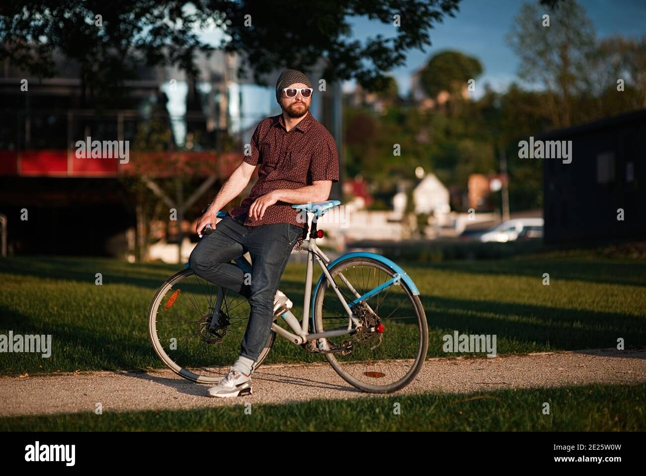 A handsome male with bicycle and backpack Stock Photo - Alamy
